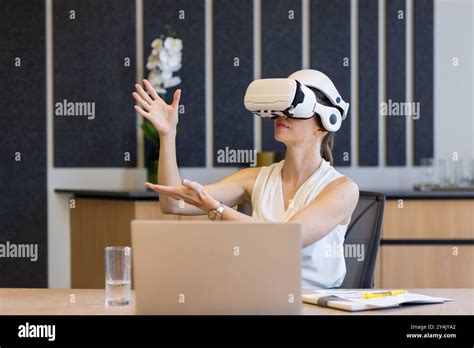 Using Vr Headset Businesswoman Interacting With Virtual Environment At Office Desk Technology