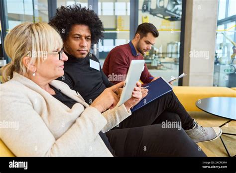 three colleagues collaborating on robotics programming and development