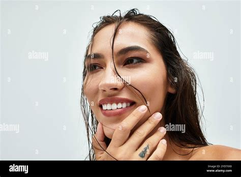 Bright Smiles Radiate From A Woman With Wet Hair As She Playfully