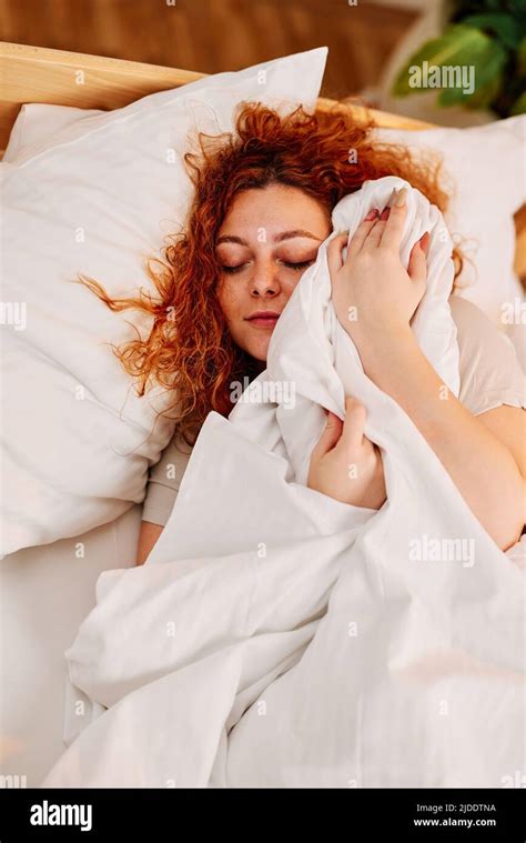 Lazy Redhead Girl In The Bed A Lazy Ginger Girl Lying In Her Bed In The Morning Covering Her