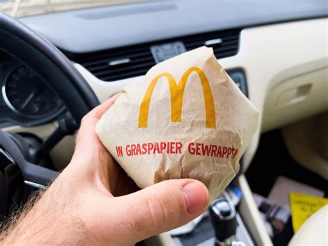 Man Enjoying A Mcdonalds Burger In His Car Editorial Photo Image Of