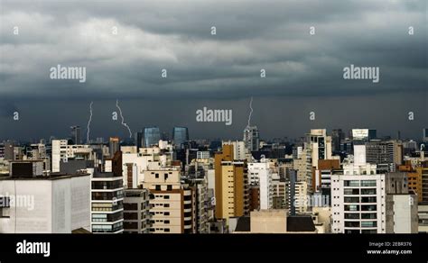 City Skyline Of An Afternoon Lightning Storm With Multiple Lightning