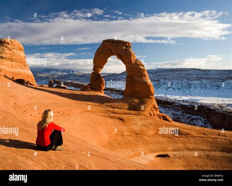 Girl Viewing Delicate Arch At Sunset In Arches National Park Utah Usa