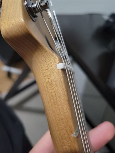 My Low E String Doesnt Sit Deeply In The Hole Of The Nut Of My Strat Is It Normal Or Should The