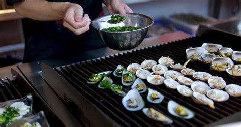 Person Grilling Sea Snails On An Outdoor Grill Snail Sea Seafood