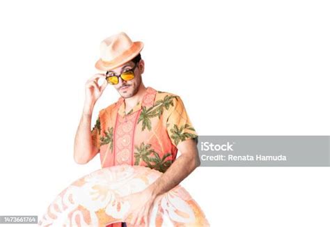 하와이안 셔츠와 모자를 쓴 놀란 젊은 관광객의 초상화는 풍선 플로트 흰색 배경 여름 스튜디오 초상화를 들고 선글라스를 통해 보입니다 휴가 및 관광 개념 남자들만에 대한 스톡