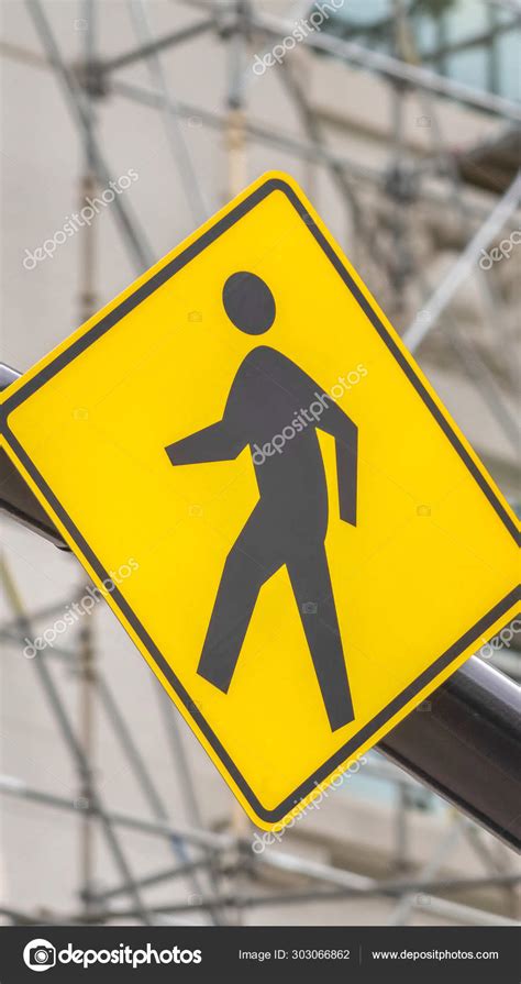 Yellow Diamond Shaped Sign With Black Symbols