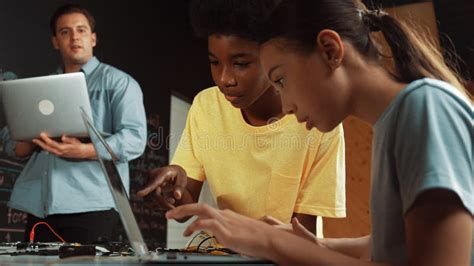 Girl Programing Or Coding System While African Boy Fixing Model