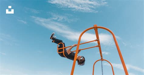 낮 동안 푸른 하늘 아래에서 주황색과 검은색 롤러코스터를 타는 검은 재킷을 입은 남자 사진 Unsplash의 무료 사람의 이미지