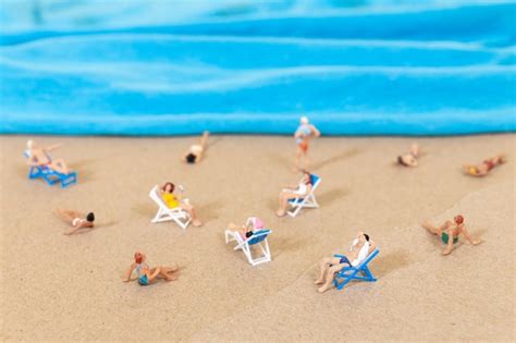 Premium Photo A Tiny Person In A Swimsuit Is Relaxing On The Beach In