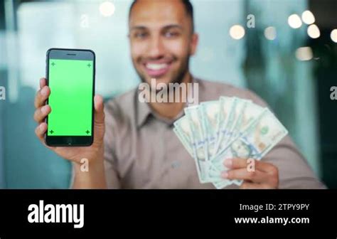 Surprised Happy Man Holding Money And Showing Mobile Phone App With