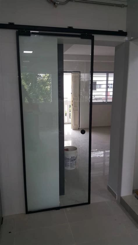 Sleek And Stylish Single Panel Sliding Glass Door With Black Frame