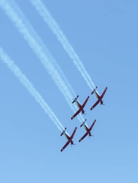 Premium Photo Low Angle View Of Airplane In Flight Against Blue Sky