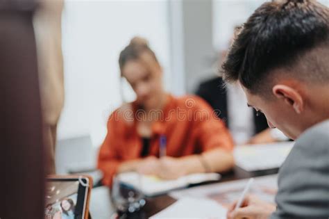 Colleagues Intensely Engaged In A Brainstorming Session Collaborating On Project Ideas During A