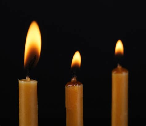 Premium Photo Burning Candles On Black Background