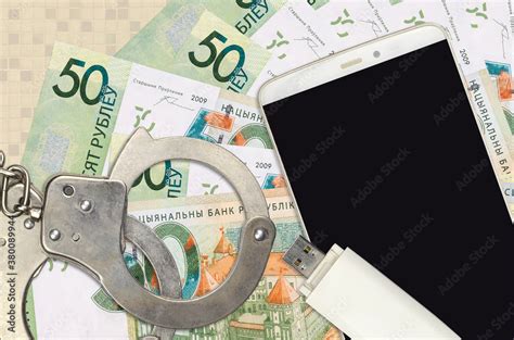 50 Belorussian Rubles Bills And Smartphone With Police Handcuffs