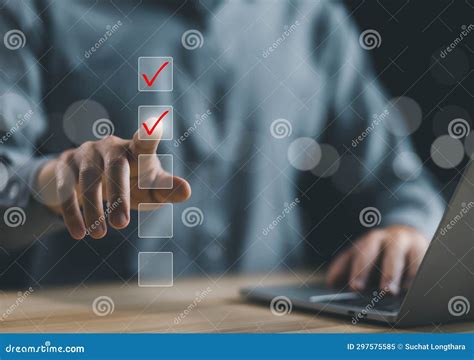 The Person Ticks The Checkmark In The Box On The Laptop On The List Of Documents Stock Image