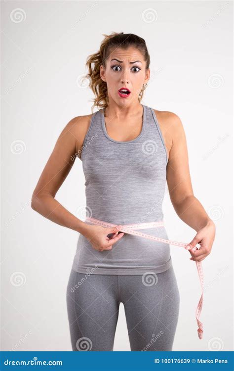 Happy Fitness Girl Measuring Her Waist With Tape Measure Stock Image