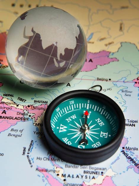 Premium Photo High Angle View Of Crystal Ball And Navigational Compass On Map