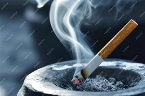 Premium Photo Closeup Of A Lit Cigarette In An Outdoor Ashtray Smoke