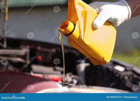 Man Pouring Motor Oil From Yellow Container Closeup Stock Image