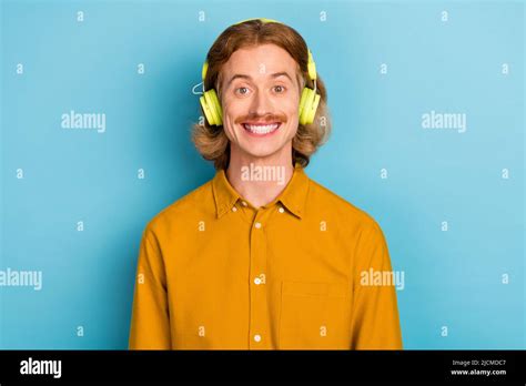 Portrait Of Attractive Cheerful Long Haired Guy Listening Different