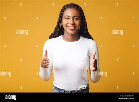 Cute Woman Showing With Hands Length Measure Symbol Isolated On Yellow Multiracial Female