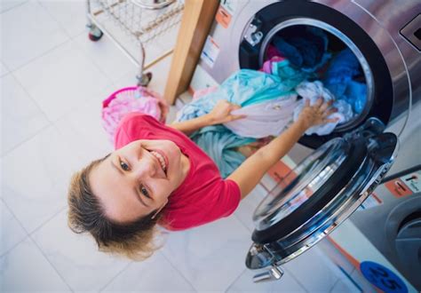 Premium Photo Young Beautiful Woman Washes And Dries Clothes In The