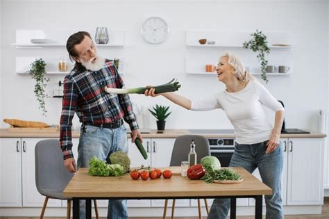 Premium Photo Happy Senior Husband And Wife Having Fun In The Kitchen