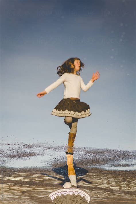 Young Girl Dancing In A Reflection In A Puddle By Stocksy Contributor