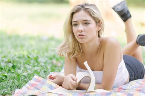 Premium Photo Young Woman Lying Down On Grass At Park