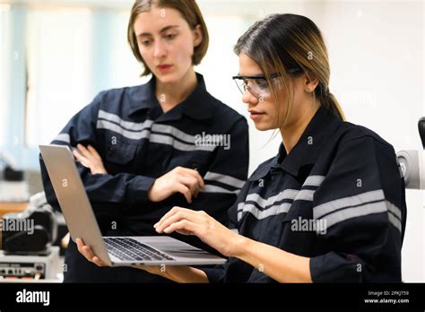 Female Engineers Using Laptop Checking And Operating Robotic Machine Stock Photo Alamy