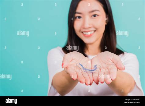Woman Smiling Holding Silicone Orthodontic Retainers For Teeth On Hand
