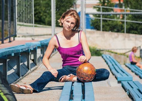 A Thin Young Girl On A Blue Bench On A Sports Stand Stock Image Image Of Lighted Lady 274649409
