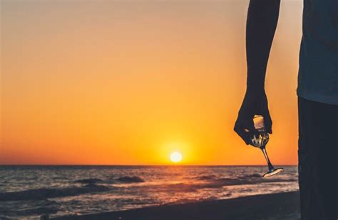Premium Photo Man At Sunset With Glass On Background Setting Sun