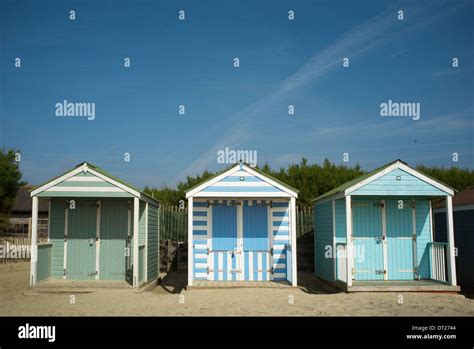 Colourful Wooden Beach Huts Along The Sandy Beach At West Wittering