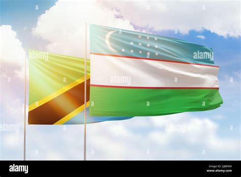 Sunny Blue Sky And Flags Of Uzbekistan And Tanzania Stock Photo Alamy