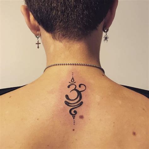 A Woman With A Tattoo On Her Back Neck