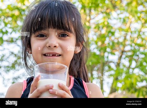 Close Up Portrait Of Her She Drinks A Glass Of Cold Milk After Playing