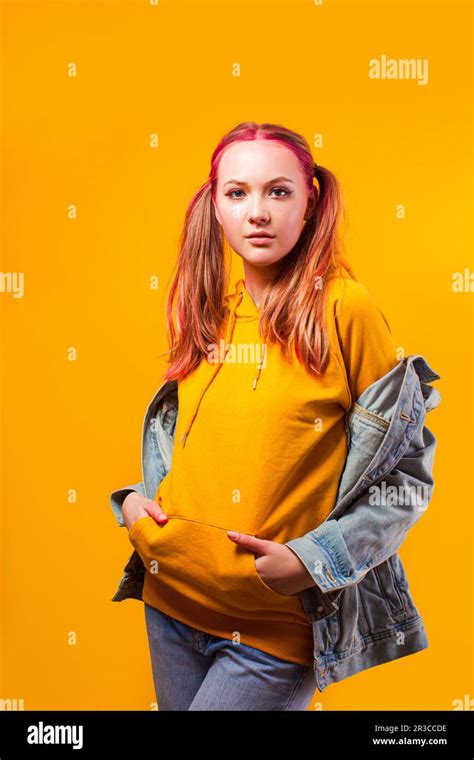 Attractive Teenage Girl Holding Her Belly On Yellow Background Stock
