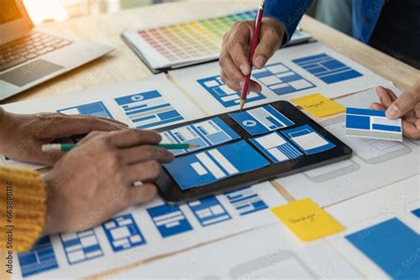 A Team Of Web Designers With The Ux Ui System Are Writing Programs And