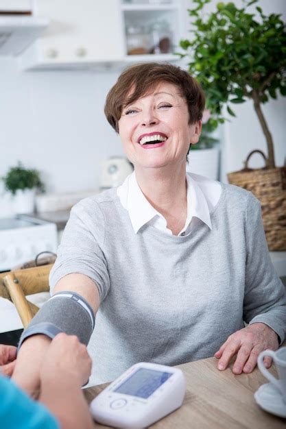 Premium Photo Gereatric Nurse Measuring Blood Pressure Of Patient