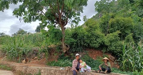 Villagers Resting On Roadside