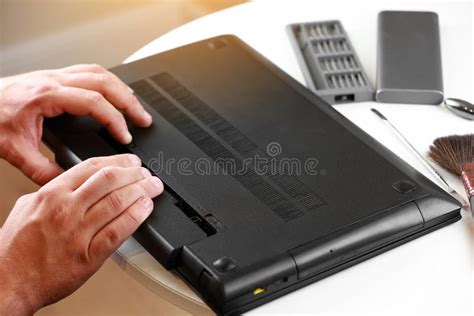 Repairman S Hands Removing The Power Battery From The Laptop Computer