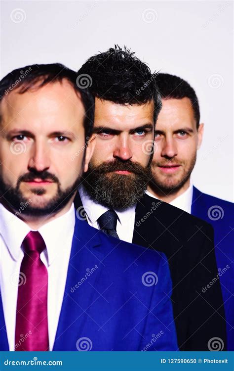 Businessmen With Strict Faces In Formal Wear On Grey Background Stock