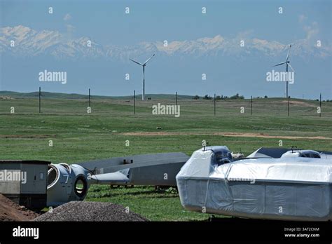new parts of wind turbines are laid out in an open field for subsequent