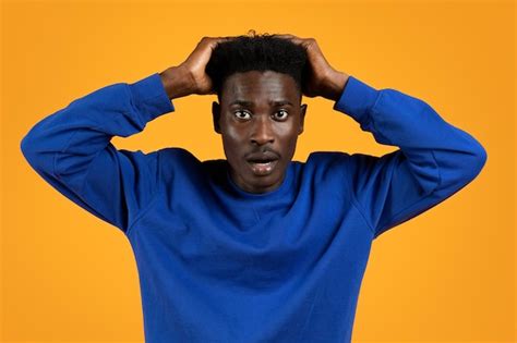 Chico Negro Joven Sorprendido Tocando Su Cabeza Foto Premium