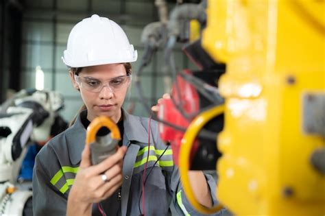 Premium Photo In The Robots Warehouse A Female Engineer Inspects The