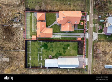 Top Down Aerial View Of A Private House With Red Tiled Roof And Frame