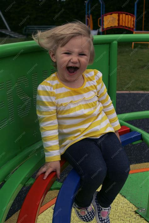 Premium Photo Cute Girl Playing On Slide At Playground